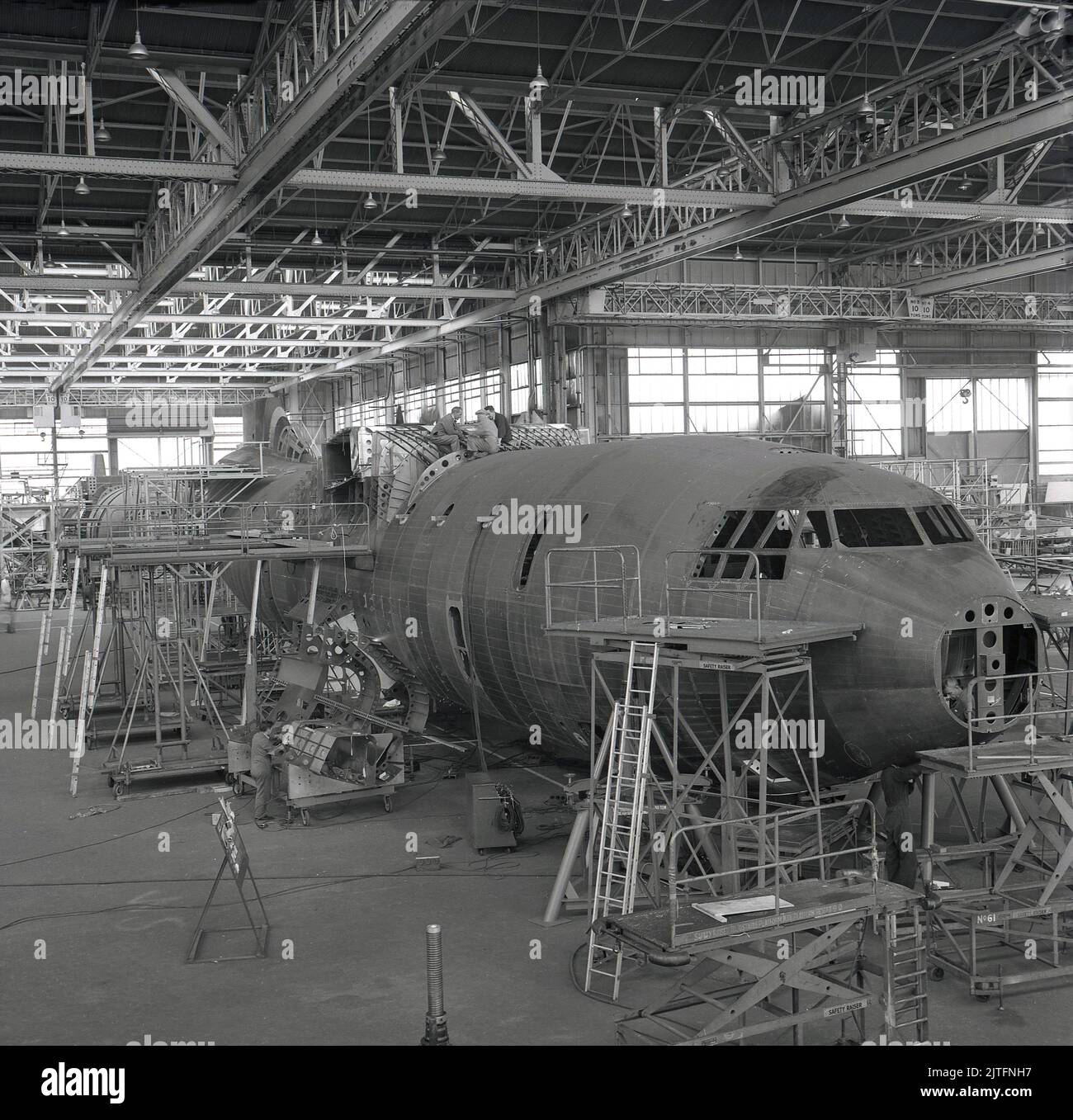 1950s, historical, aviation in this era, inside a giant hangar, an ...