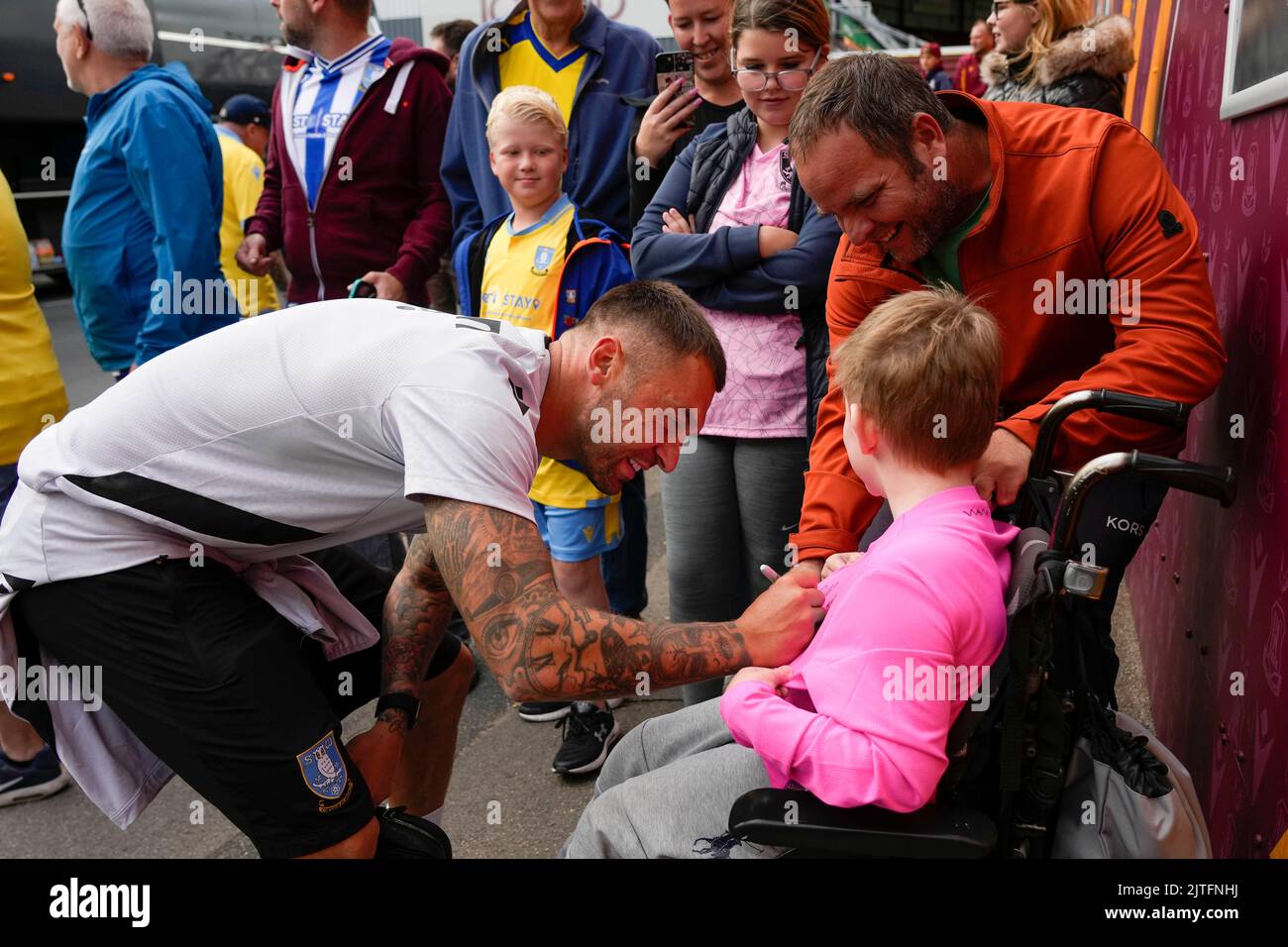 Jack Hunt #32 of Sheffield Wednesday signs an autograph for a young fan ...