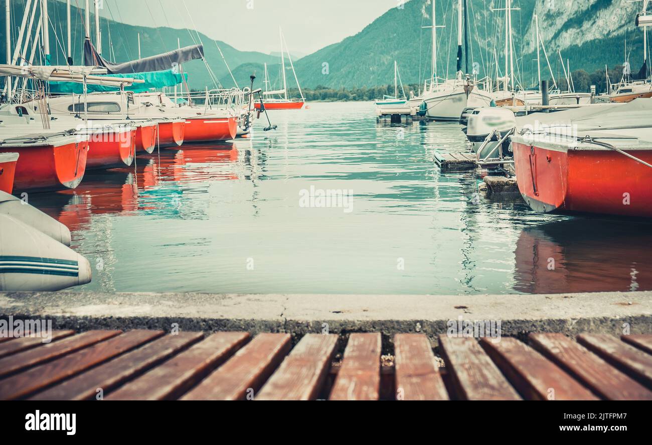 Wooden pier for mooring boats on mountain lake in beautiful sunny day ...