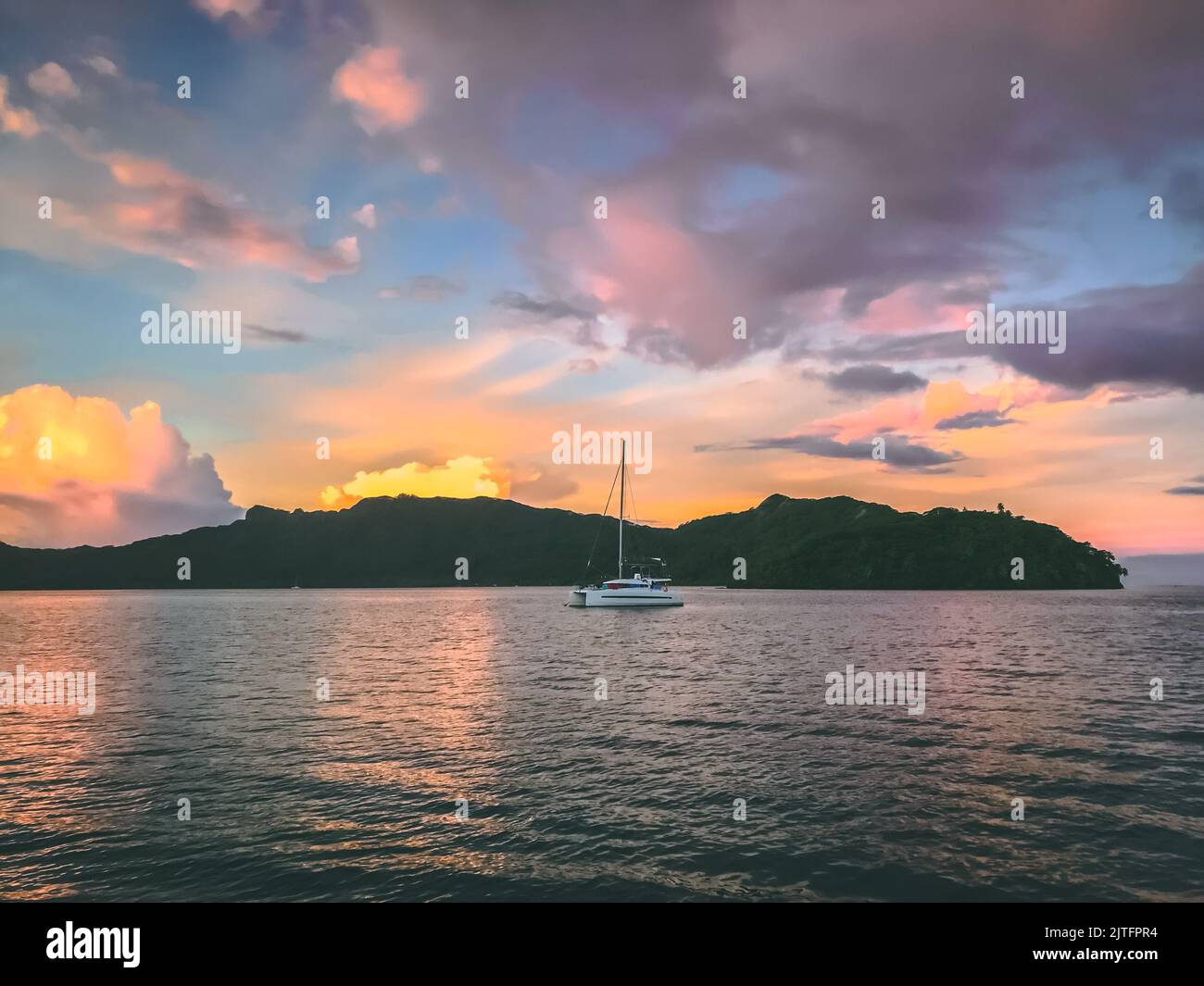 Colorful sunrise seascape landscape. Yacht sailing under bright orange ...
