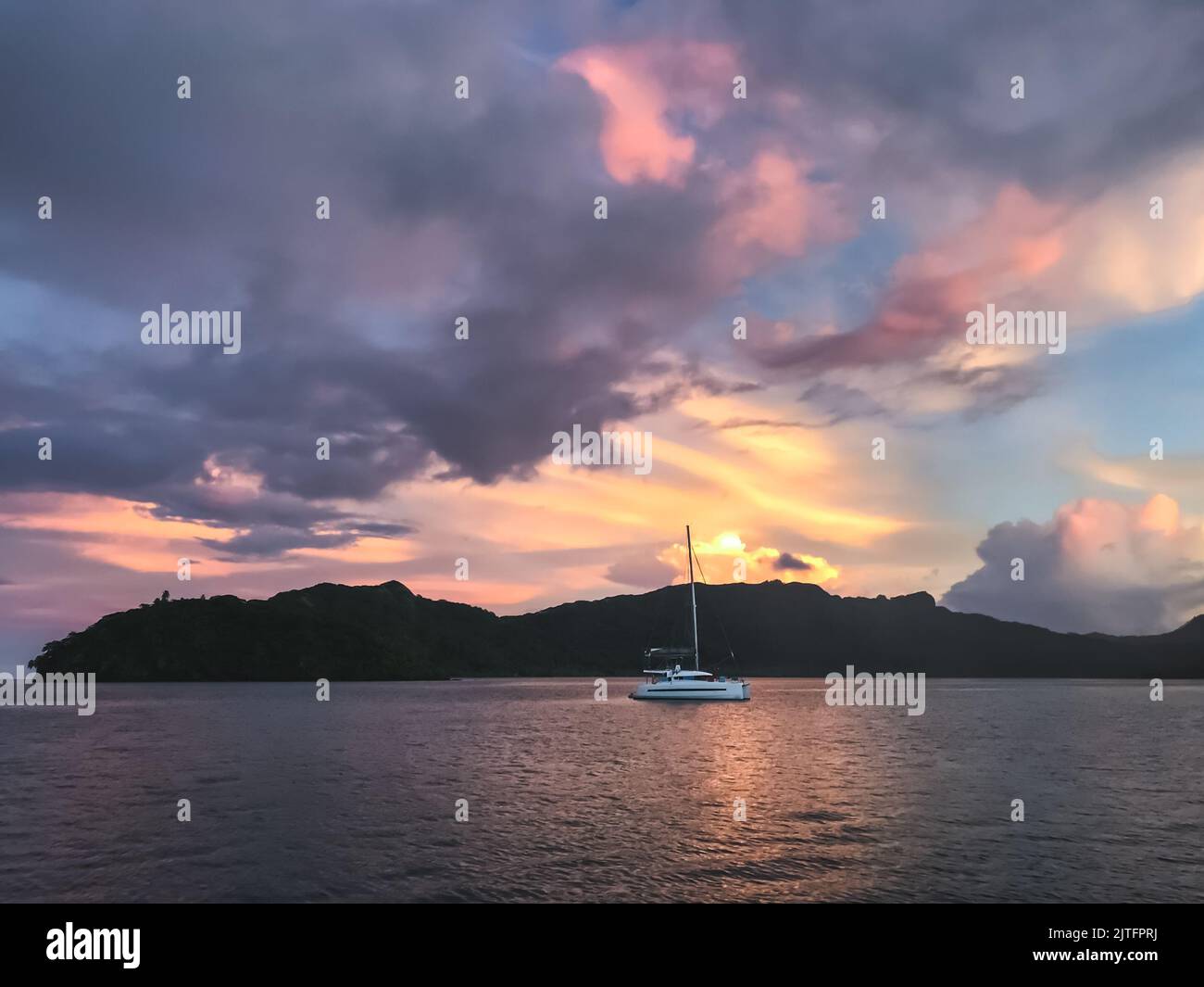 Dramatic sunset ocean scene. Yacht sailing calm sea water under vibrant ...