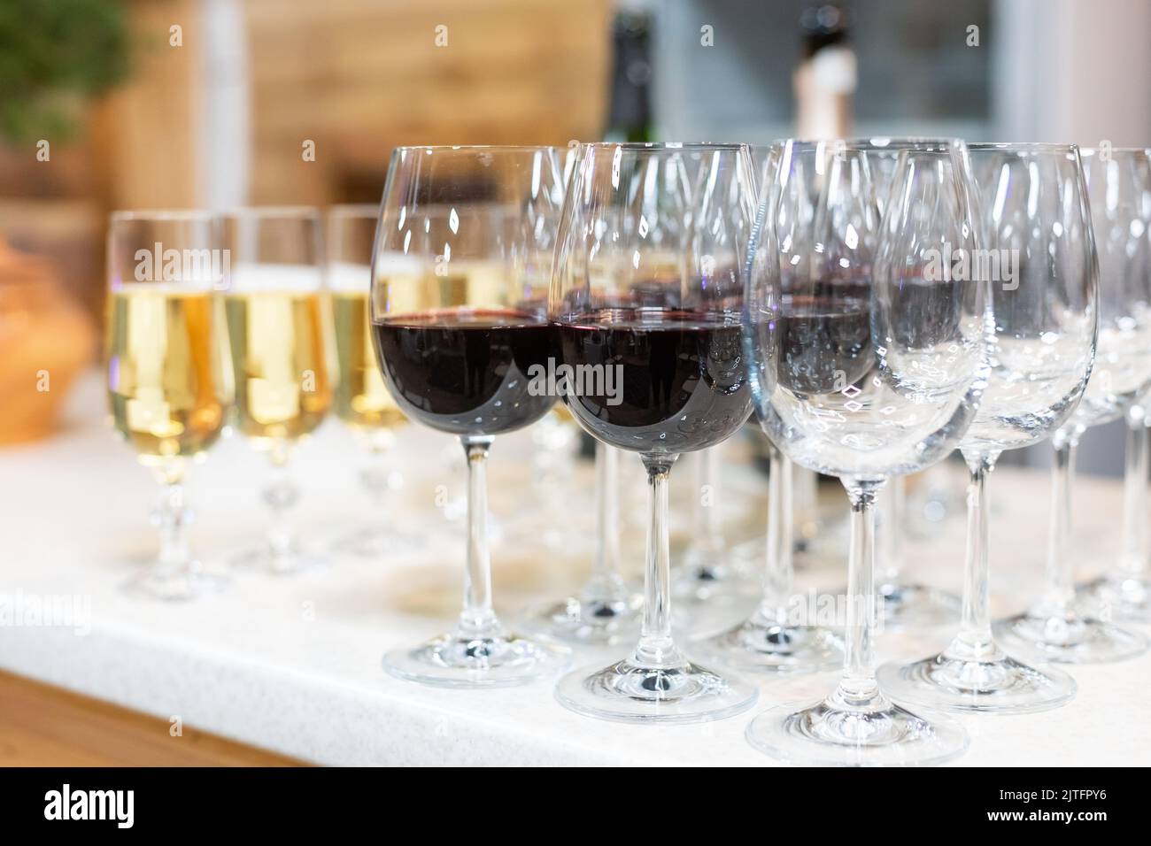 Many glasses of different wine in a row on bar counter Stock Photo - Alamy