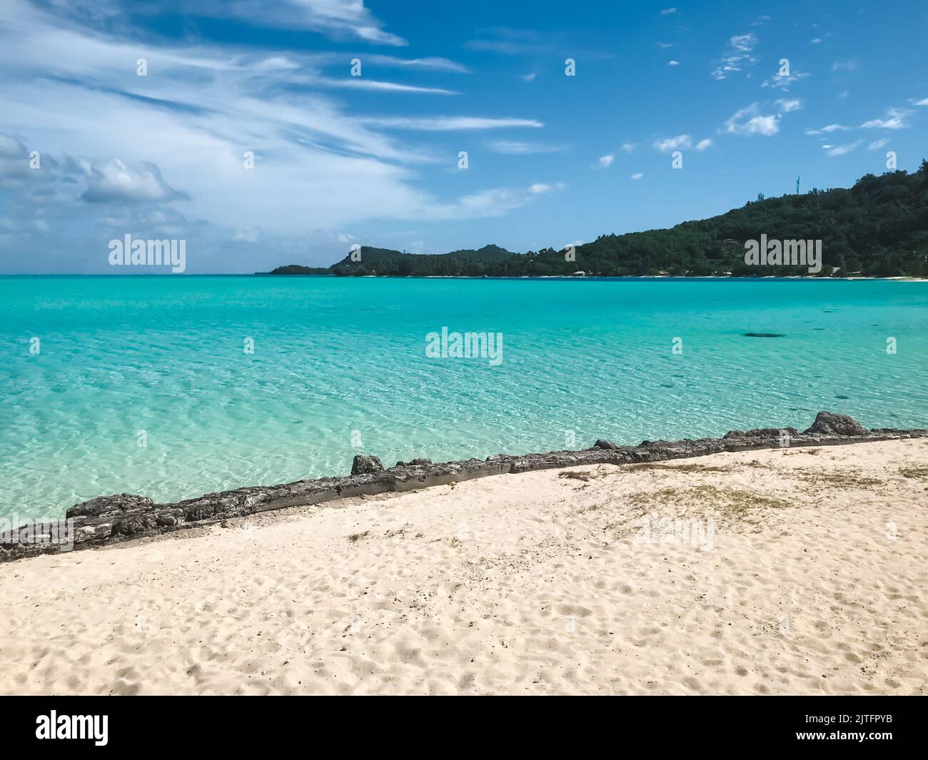 White sand beach tropical island with turquoise water and bright blue ...
