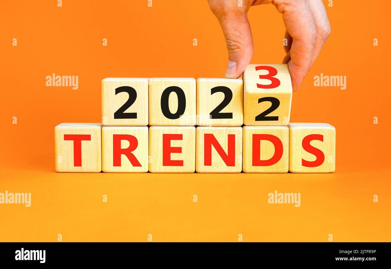 2023 review new year symbol. Businessman turns a wooden cube and ...