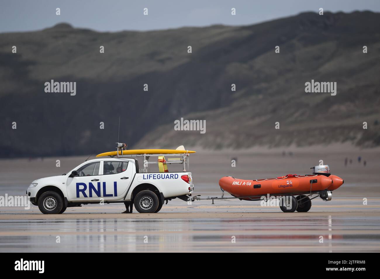 RNLI rescue vehicle towing a rib on the beach Stock Photo - Alamy