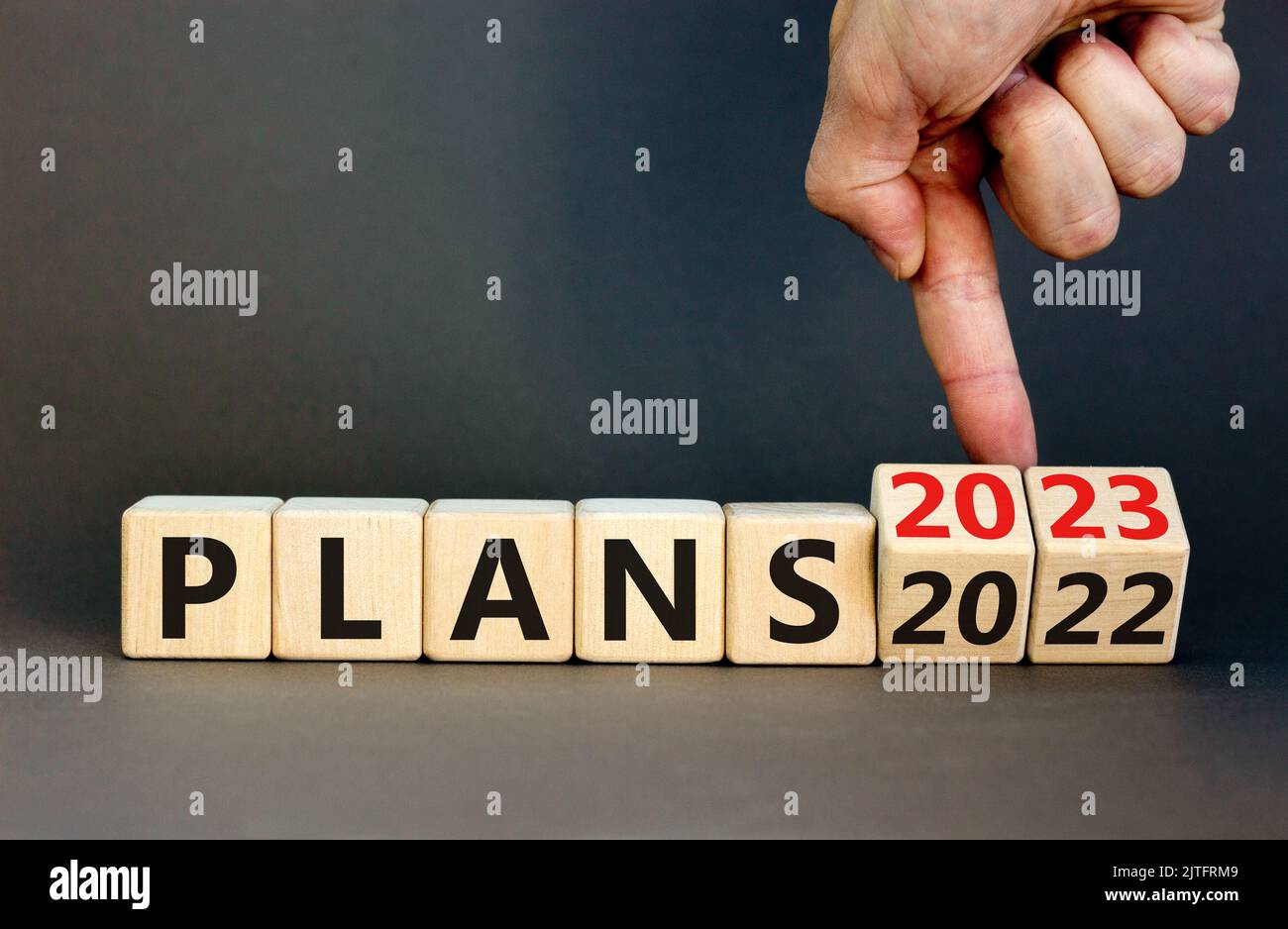 2023 plans new year symbol. Businessman turns a wooden cube and changes ...