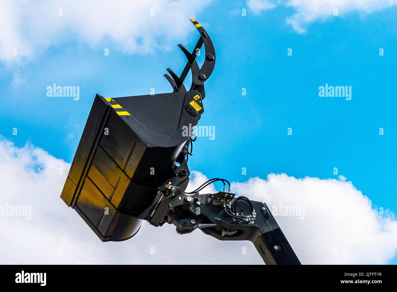 Excavator bucket close-up on ble sky. Industrial Excavator Machine ...