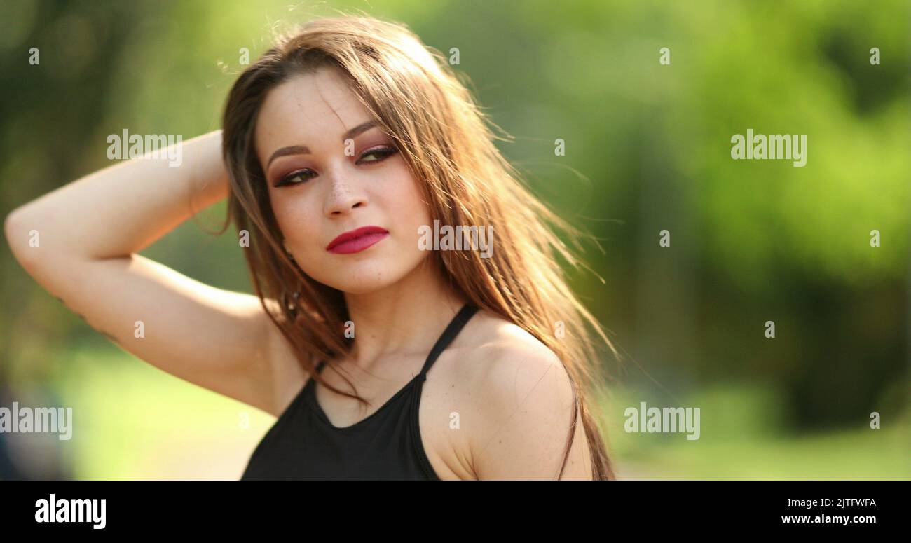 Pretty millennial girl posing in outdoor park nature Stock Photo - Alamy