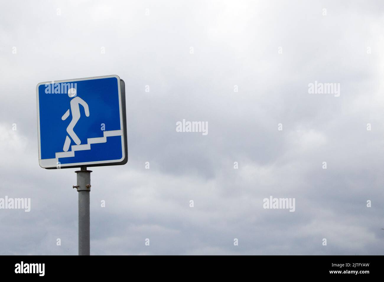 Warning blue road sign of an underground passage at the street with the ...