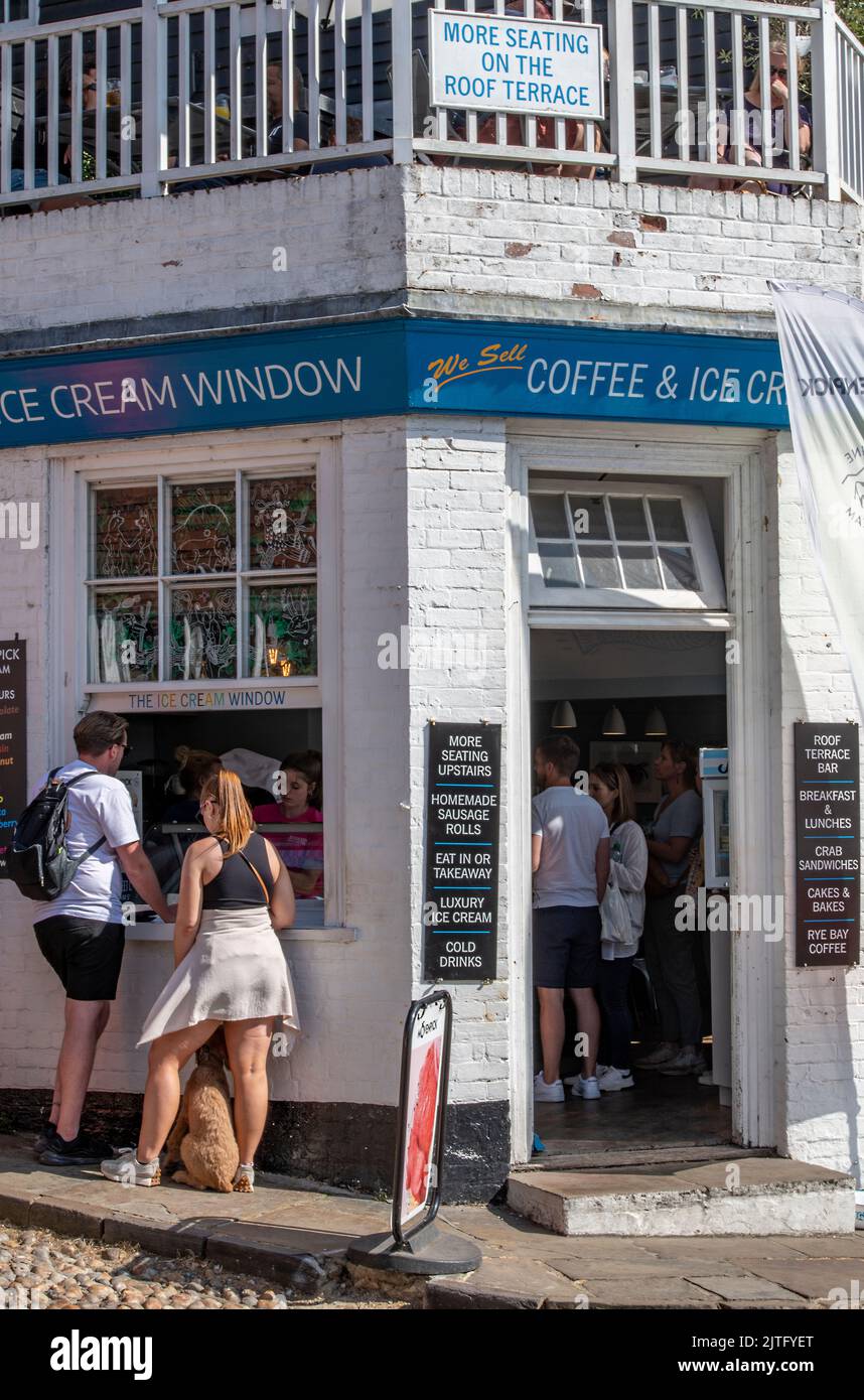 man and woman in queue at a traditional ice cream shop ini hastings on ...