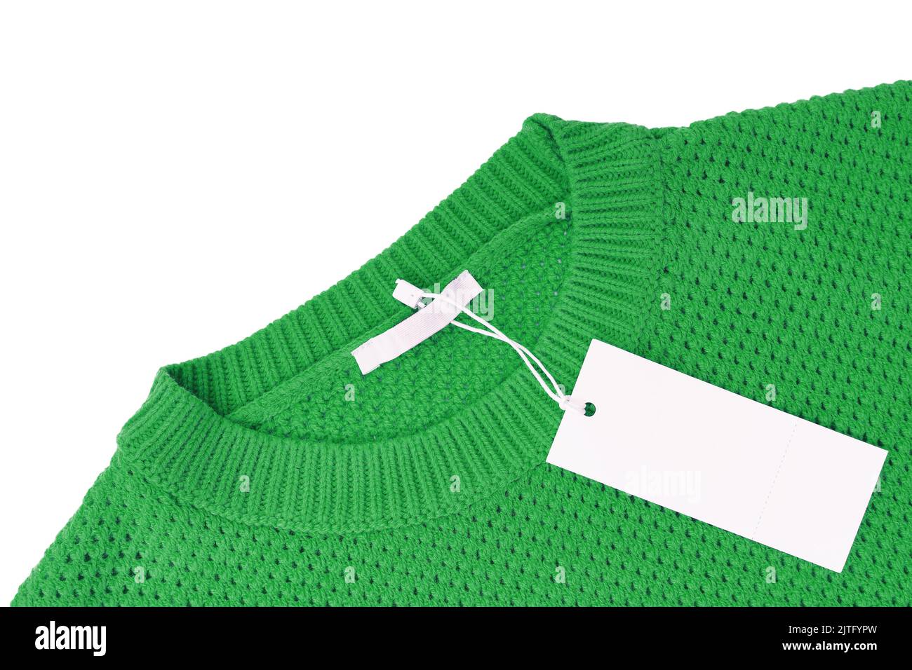 White blank rectangular clothing tag, label mockup template on green ...