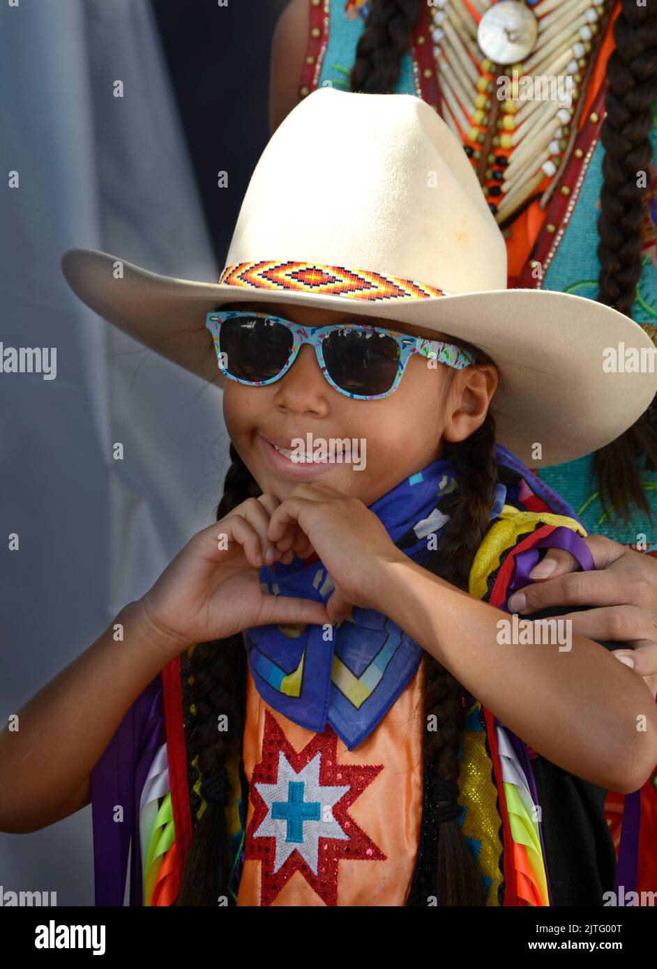 A young Native American boy makes a heart with his hands at the Santa ...