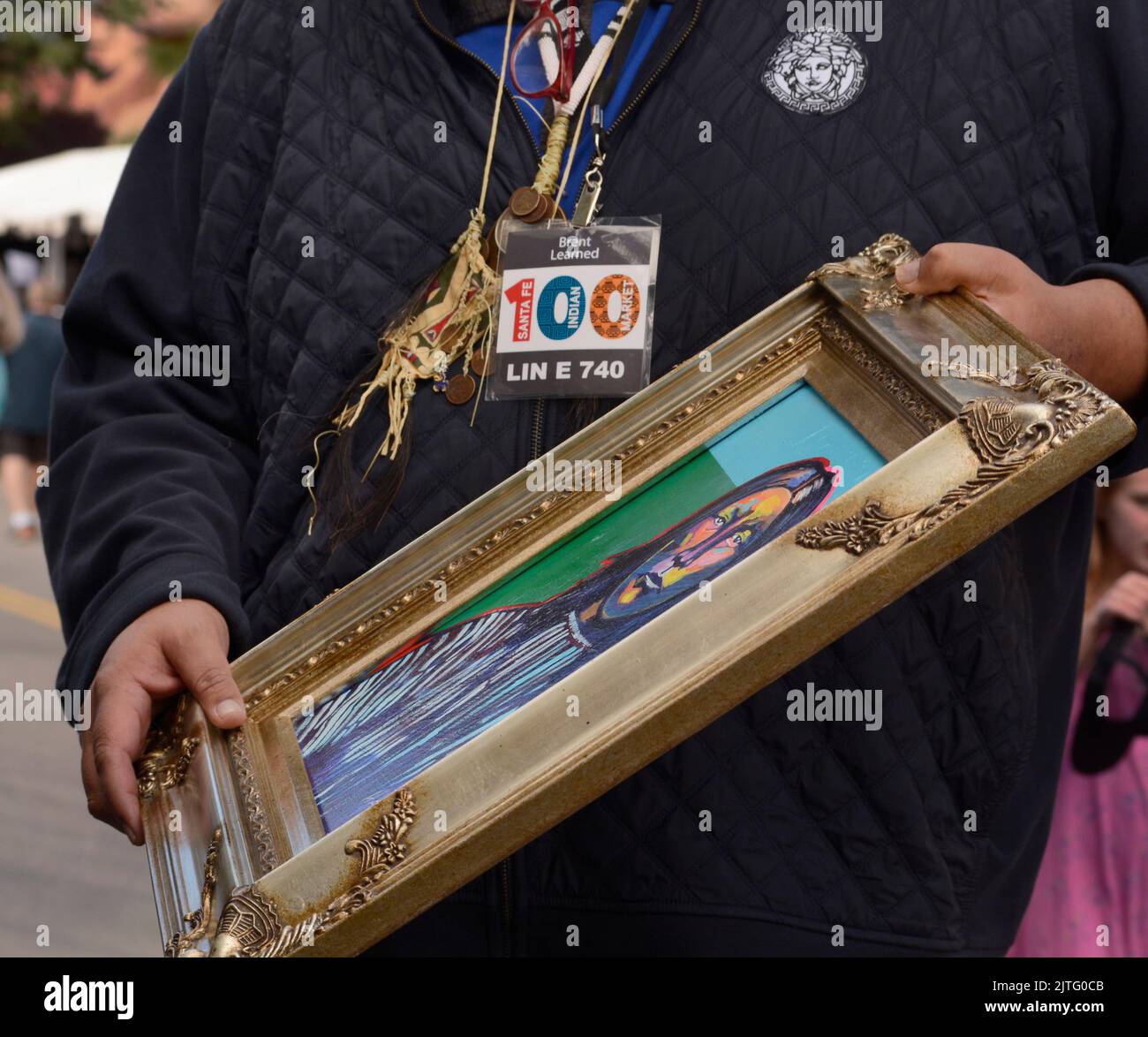 Native American artist Brent Learned holds one of his paintings for ...