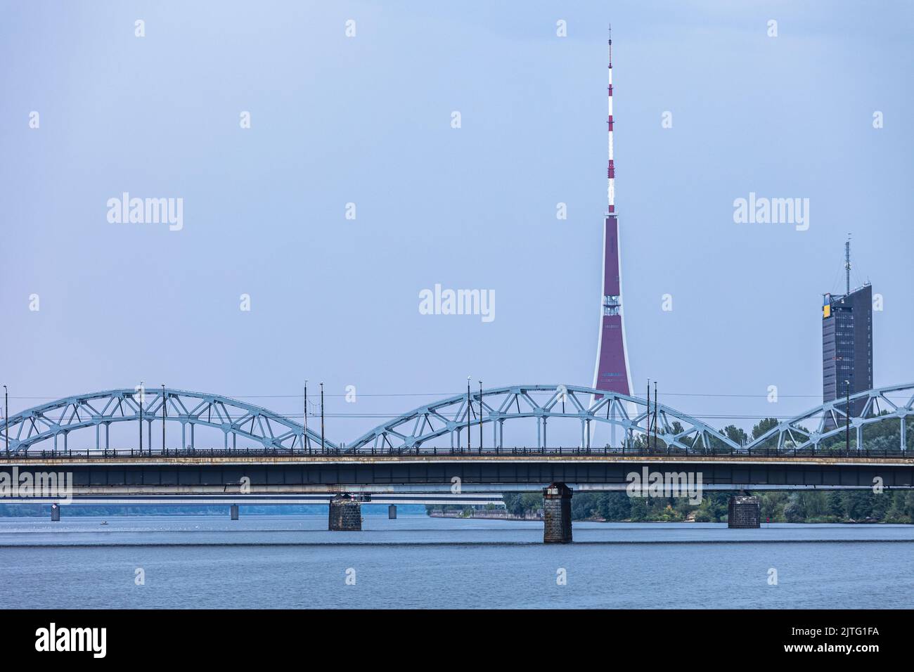 Riga Railway bridge with TV tower in background Stock Photo - Alamy