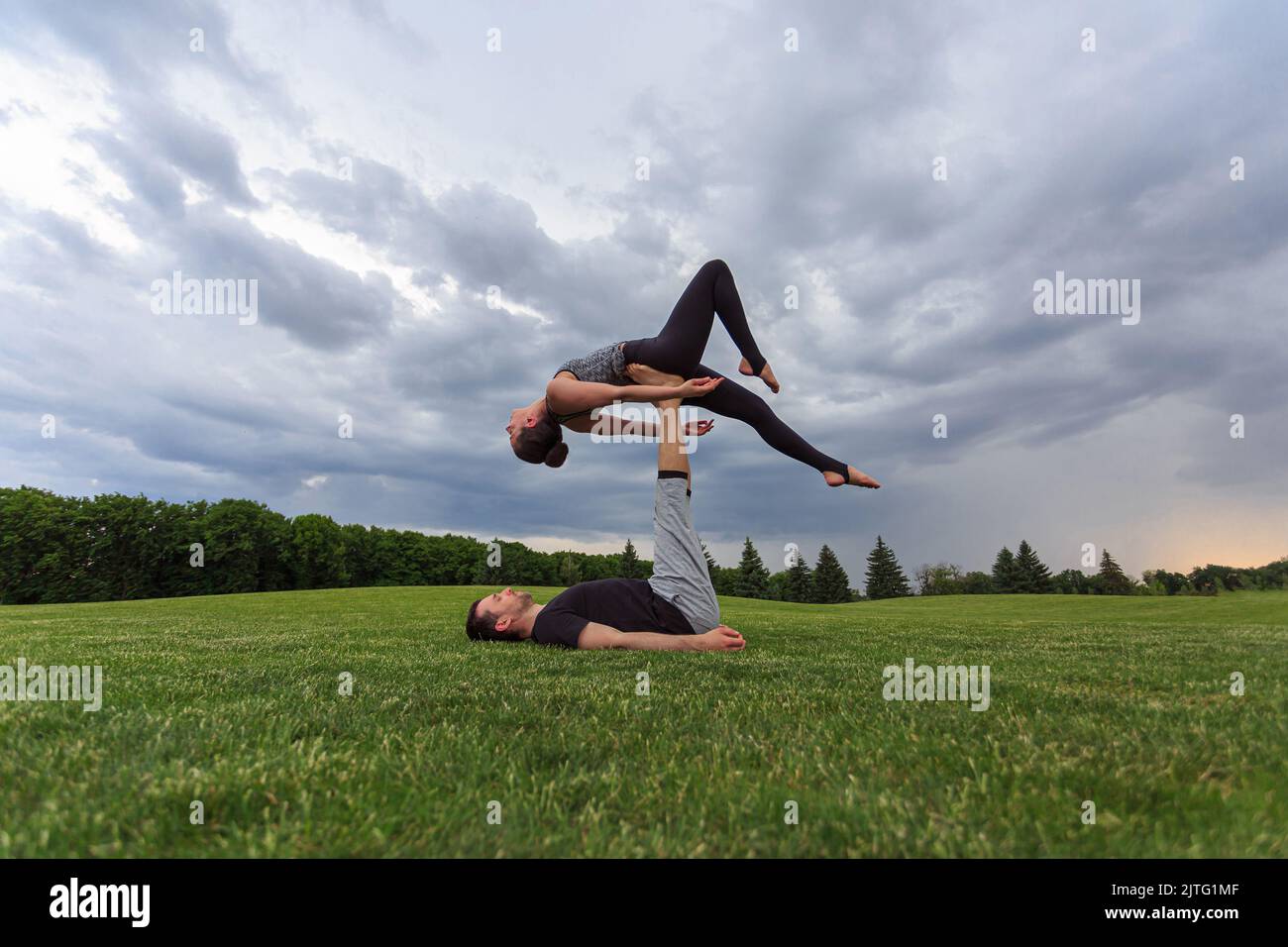 Strong acrobatic woman lifting man hi-res stock photography and images ...