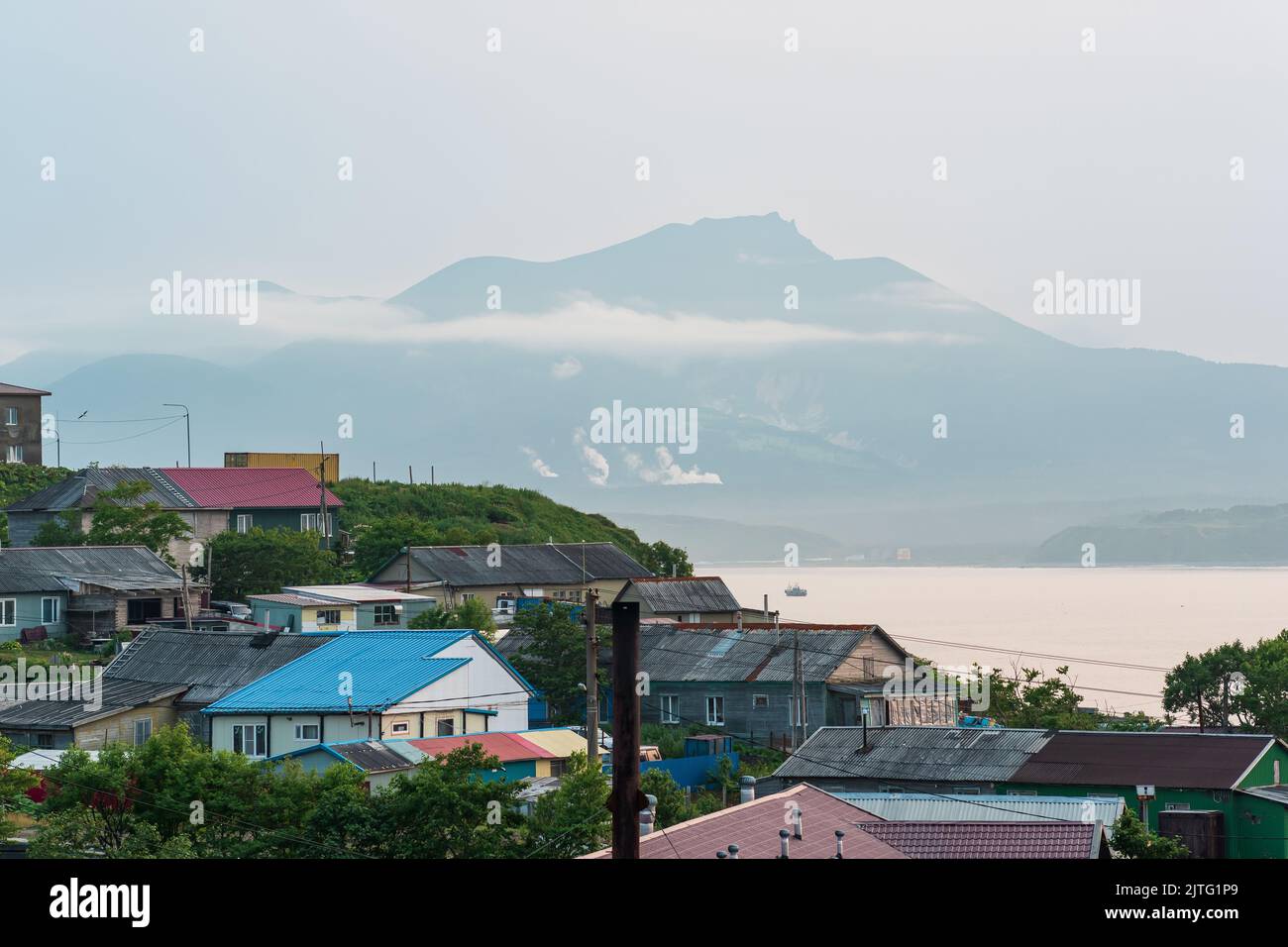 landscape of the town of Yuzhno-Kurilsk on the island of Kunashir with ...