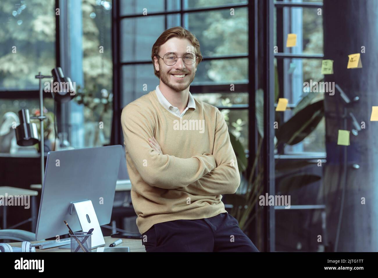 Portrait of successful young IT specialist young engineer programmer in modern loft office ...