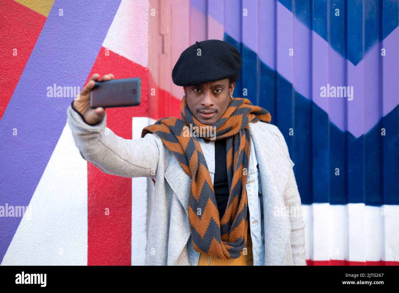 Young adult african american man taking a self portrait with mobile ...