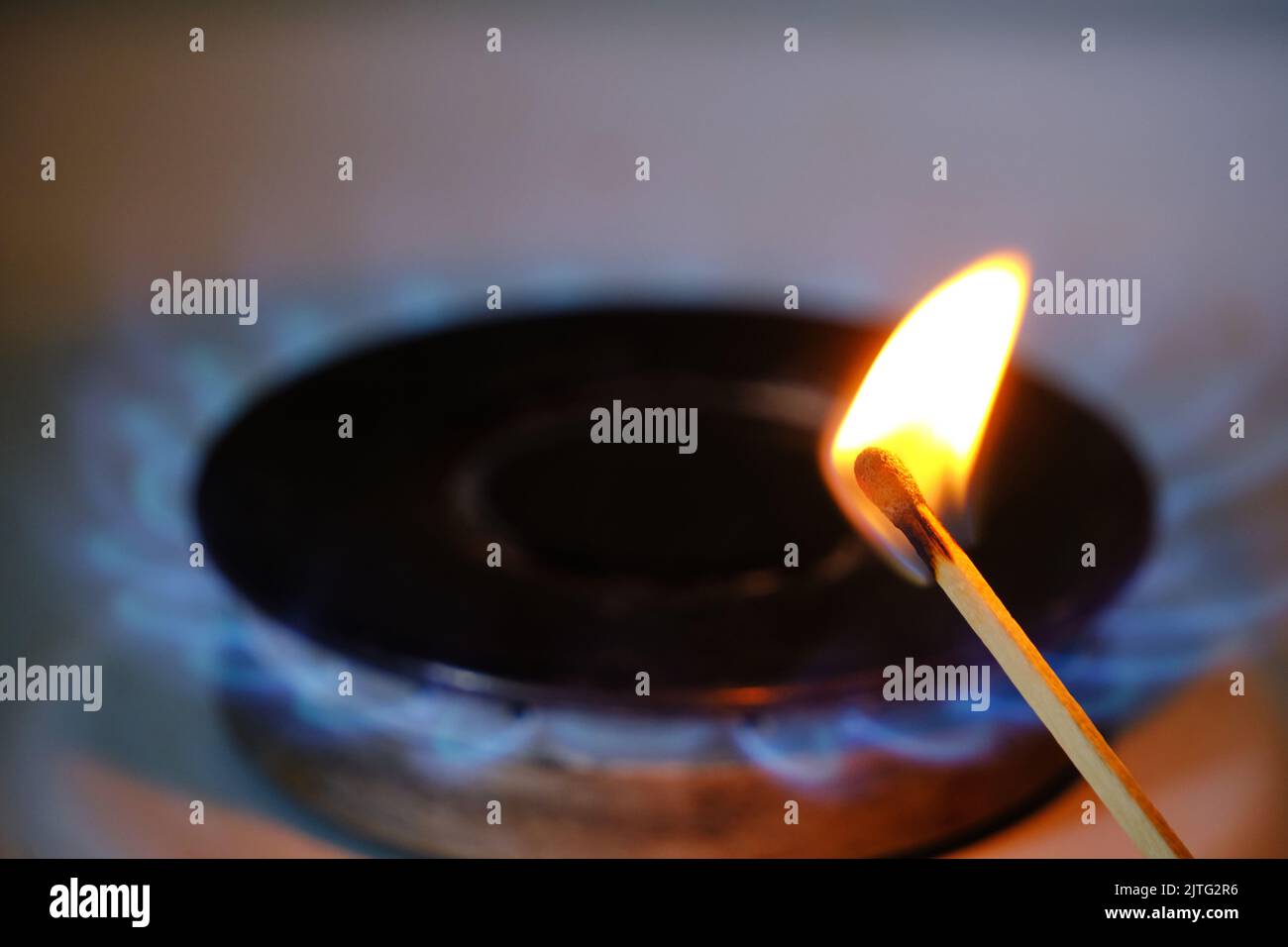 Burning match against background blue flame burning burner Stock Photo ...