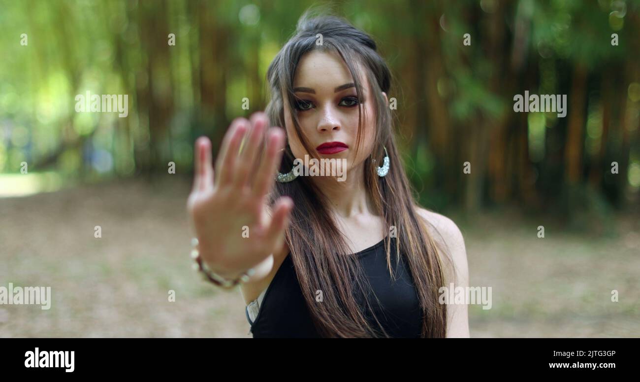 Woman annoyed making stop sign with hand, saying no, expressing defense ...