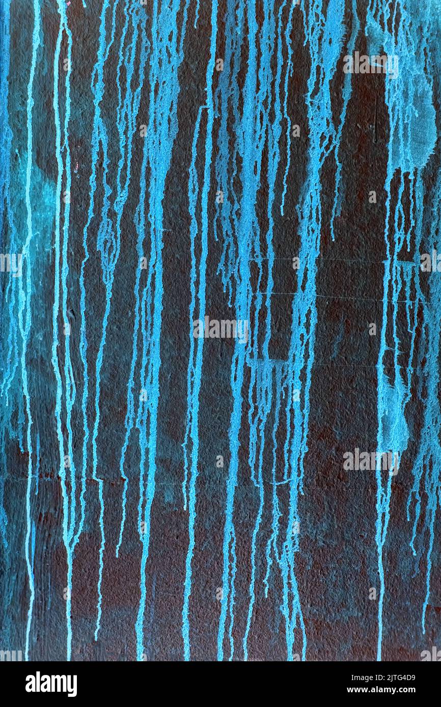 color pattern texture of down flows of light blue paint on dark black ...