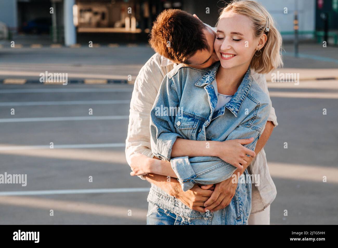 happy young couple hugging on city parking Stock Photo - Alamy
