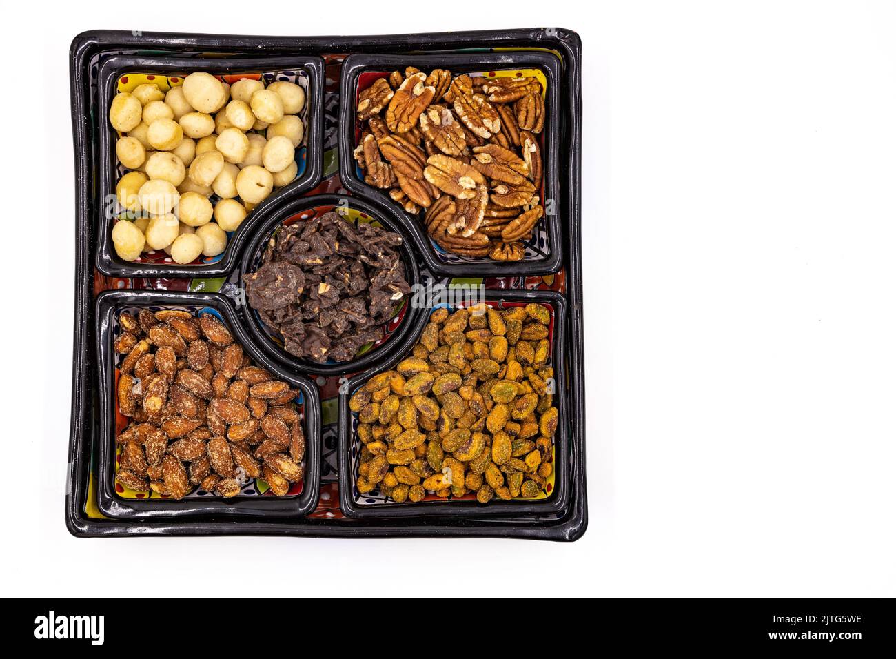 A set of healthy roasted nuts and dark chocolate in a plastic container ...