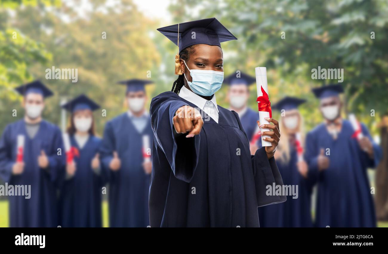 female graduate student in mask with diploma Stock Photo - Alamy
