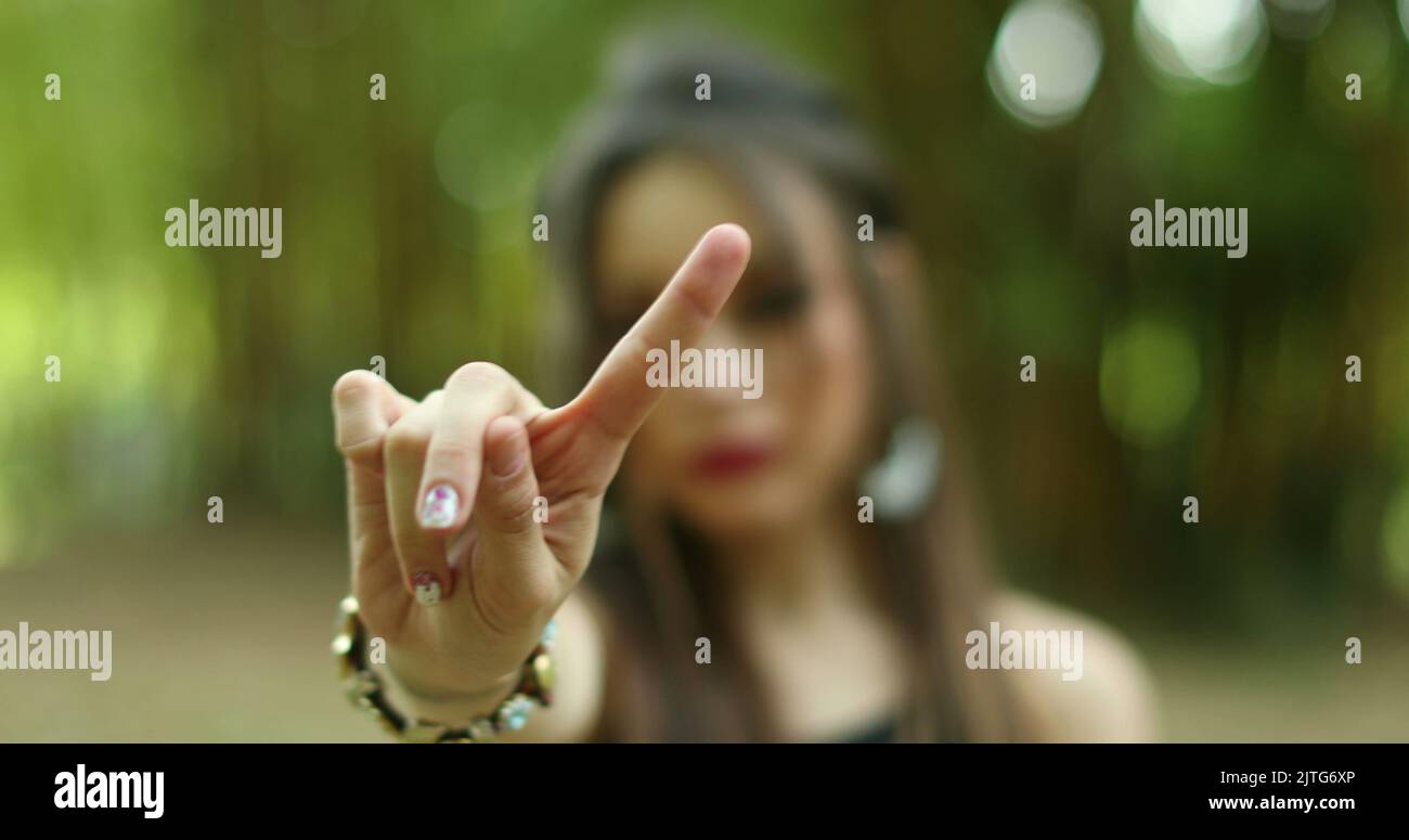 Serious defensive girl holding her hand in objection, saying NO. Young ...
