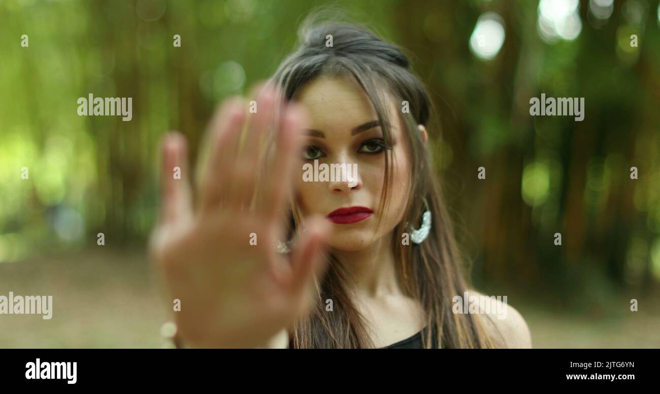Serious defensive girl holding her hand in objection, saying NO. Young ...