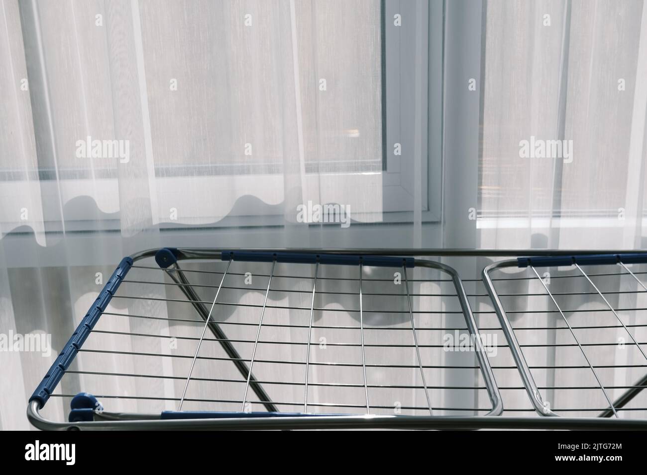 Clothes Dryer Metal Rack Laundry Home near window Stock Photo - Alamy