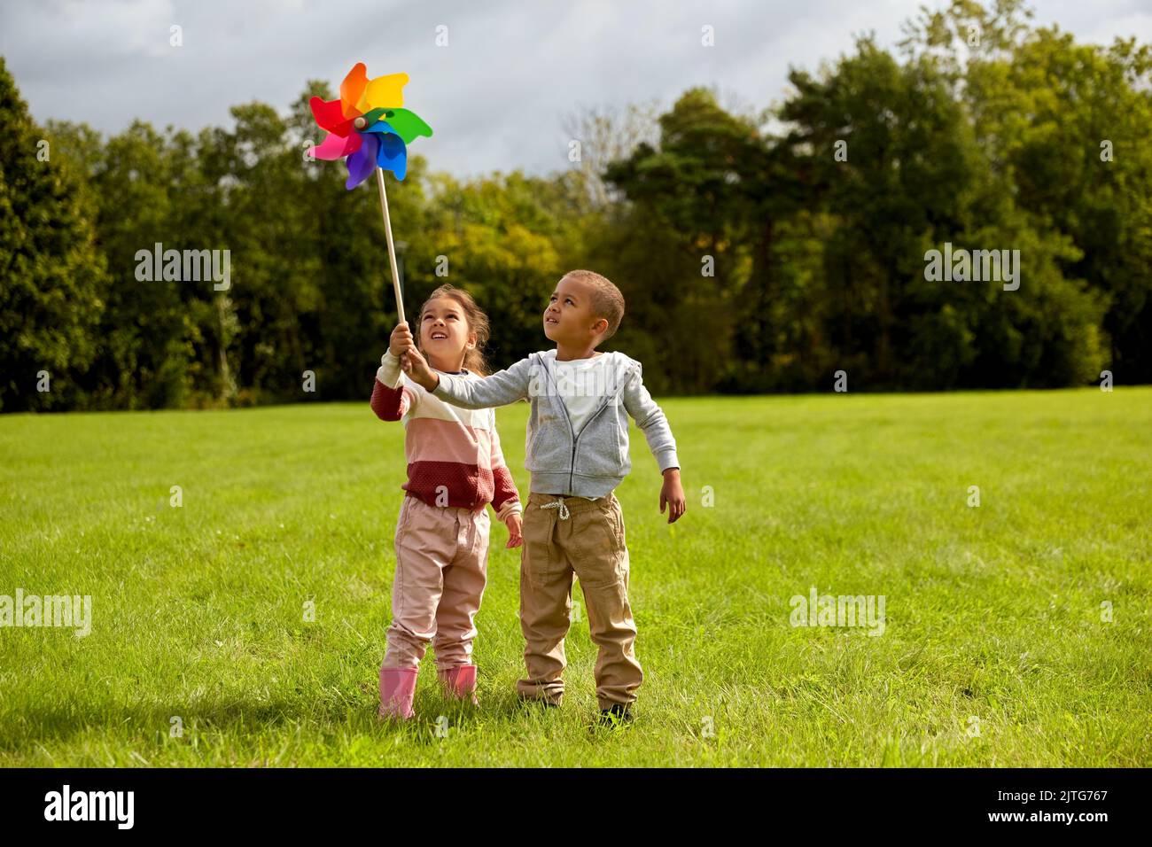 happy children playing with pinwheel at park Stock Photo - Alamy