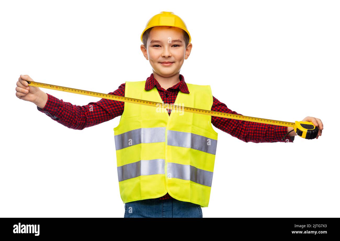 boy in construction helmet and vest with ruler Stock Photo - Alamy