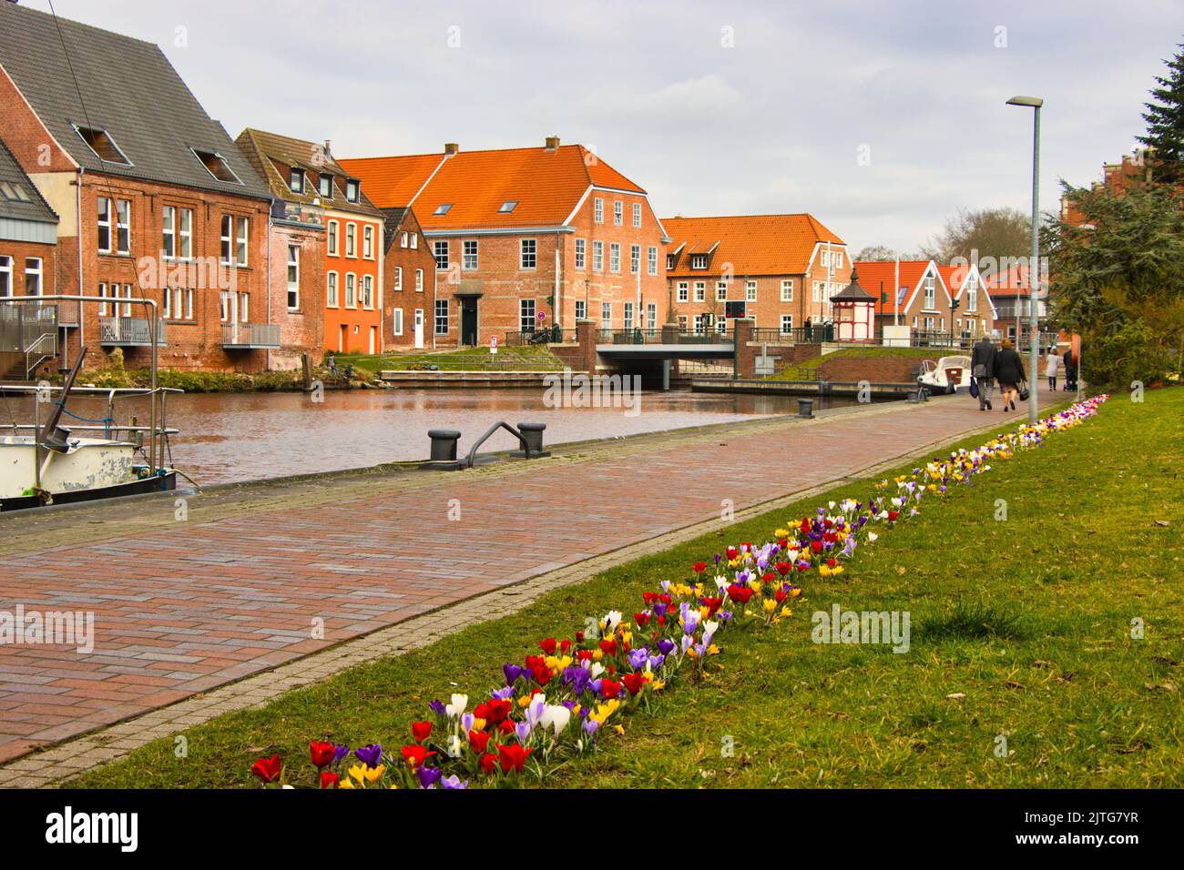 A row of medieval buildings by a river in Emden, Germany Stock Photo ...