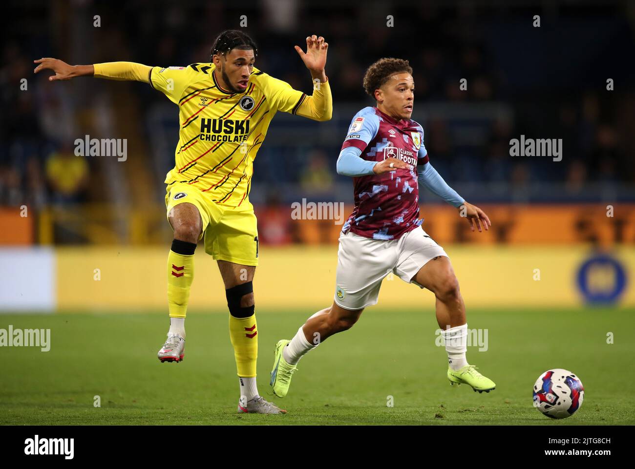 Millwall's Tyler Burey (left) and Burnley's Manuel Benson battle for ...