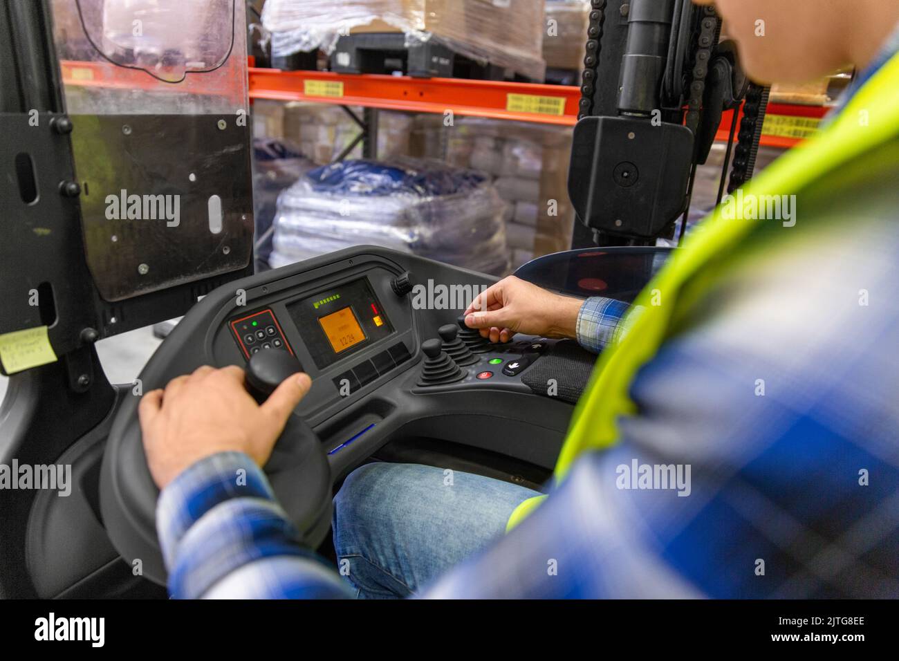 man operating forklift loader at warehouse Stock Photo - Alamy