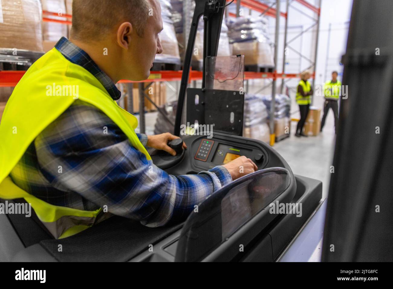 man operating forklift loader at warehouse Stock Photo - Alamy