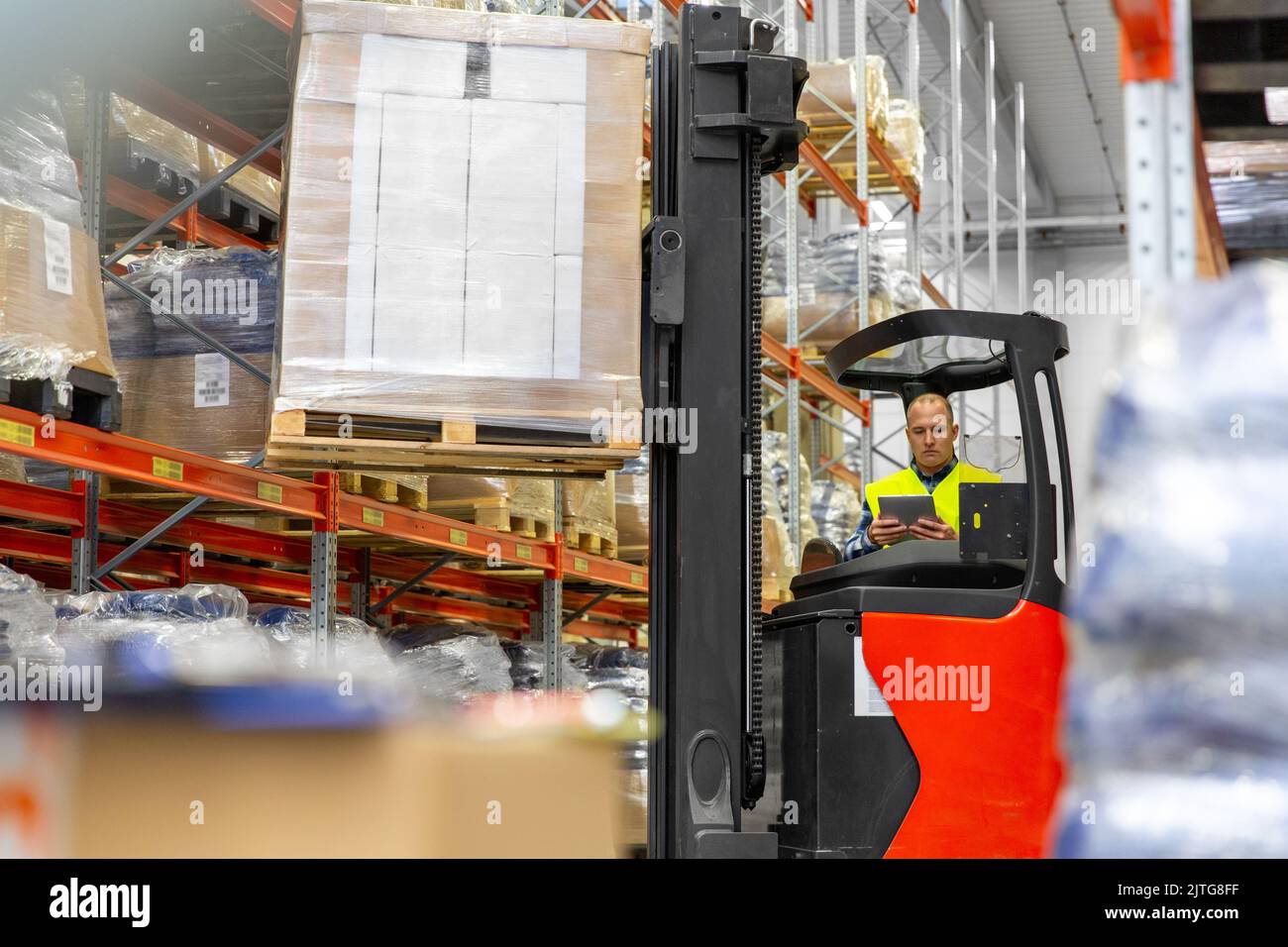 loader with tablet pc on forklift at warehouse Stock Photo - Alamy