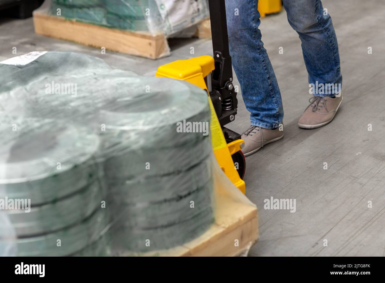 man with cargo on loader working at warehouse Stock Photo - Alamy