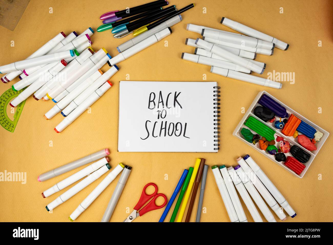 Many different office supplies. School markers, pens and plasticine ...