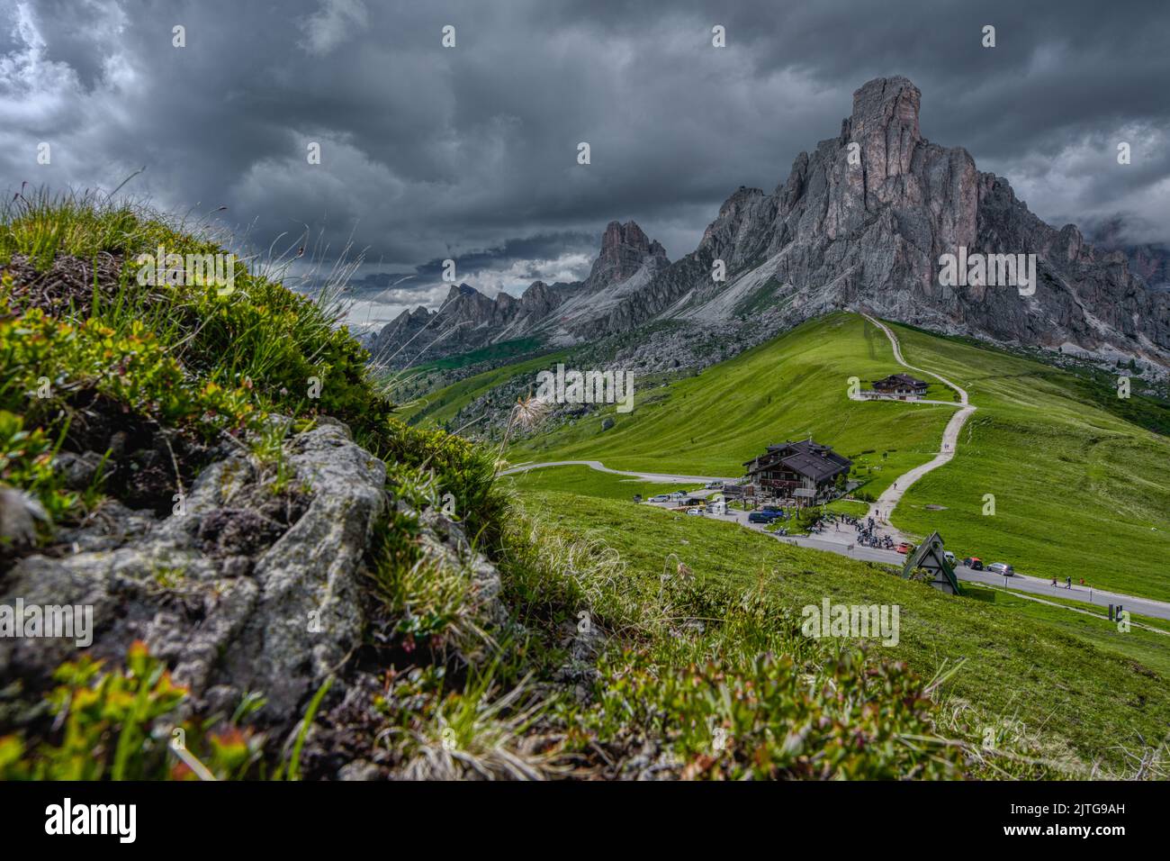 A dramatic shot of the Giau Pass and its road in the Dolomites in the ...