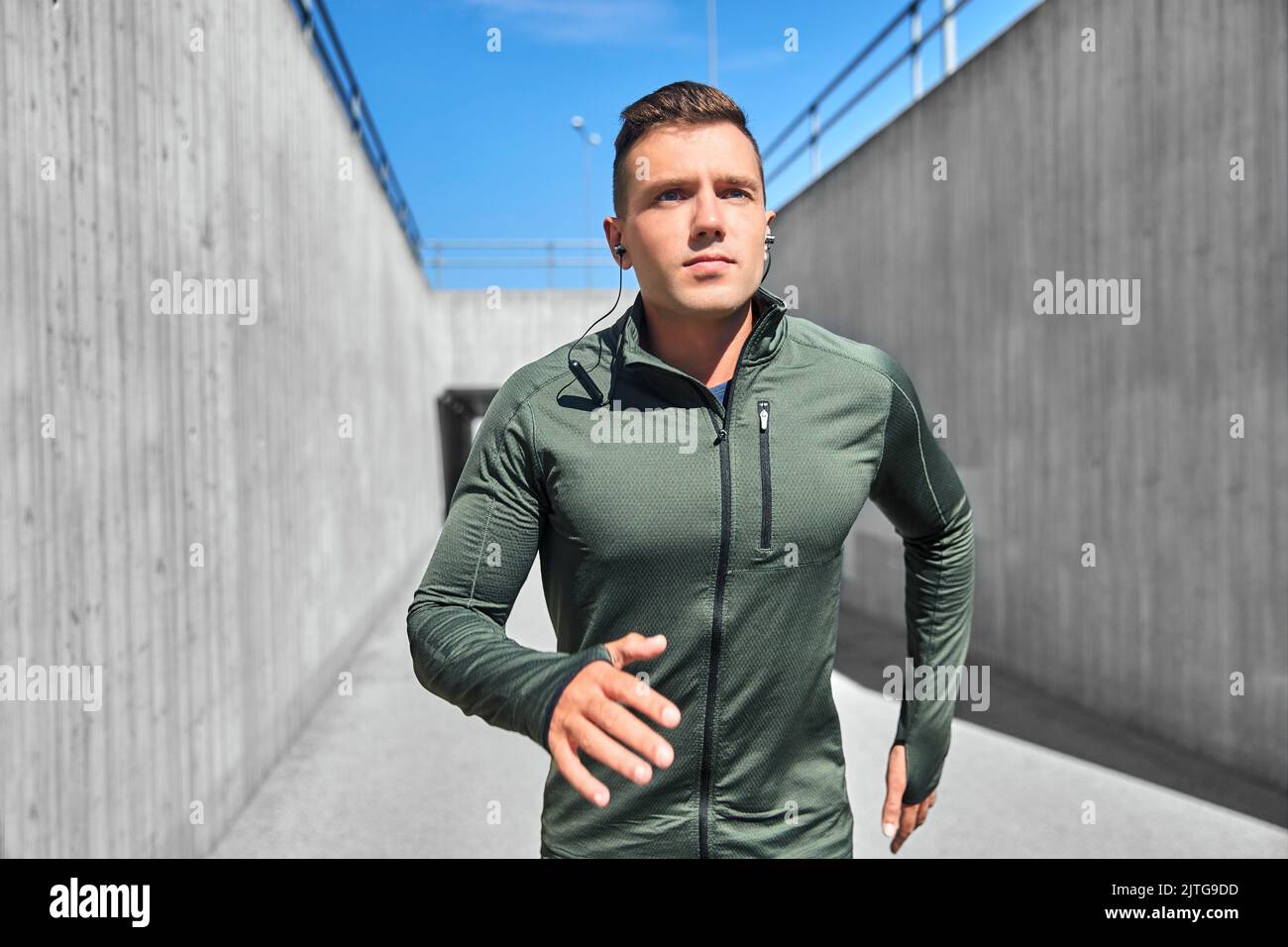 young man in earphones outdoors Stock Photo - Alamy
