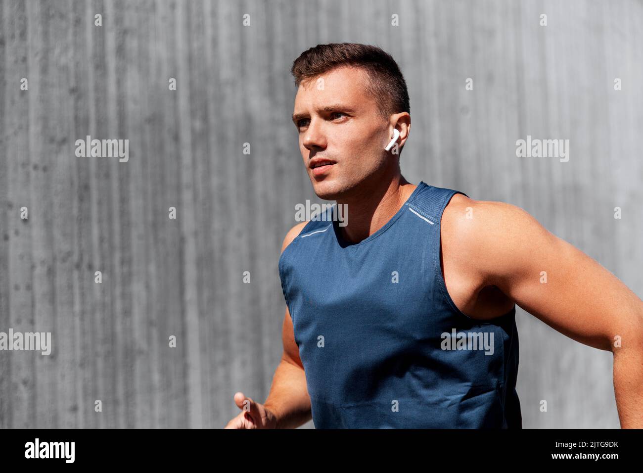 young man in earphones outdoors Stock Photo - Alamy
