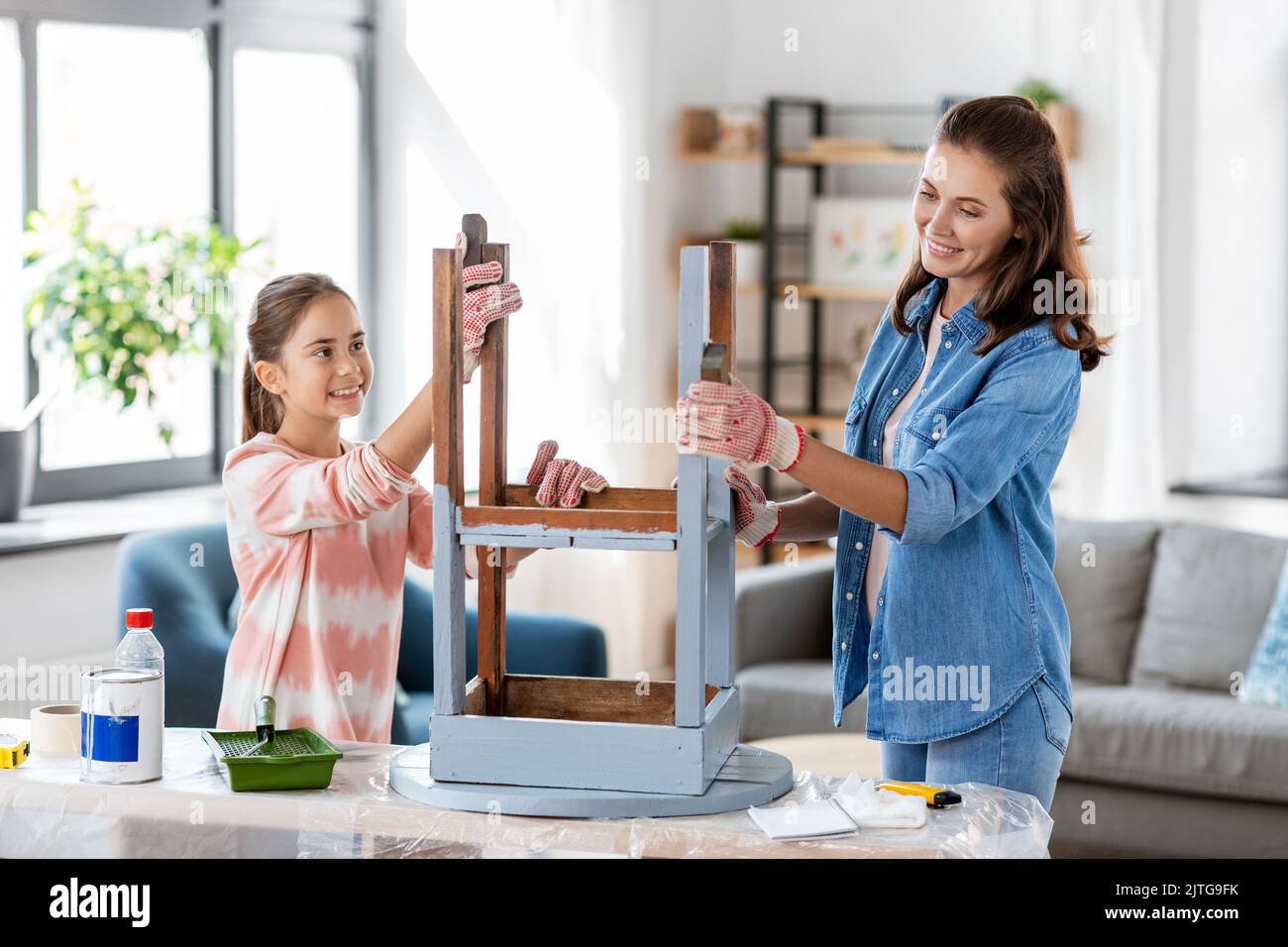 mother and daughter sanding old table with sponge Stock Photo - Alamy