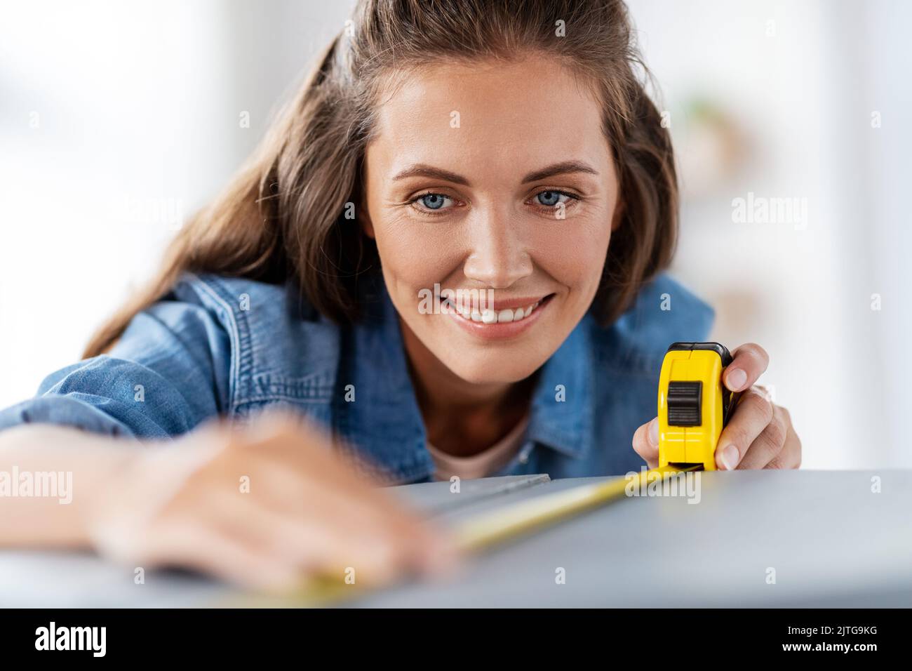 woman with ruler measuring table for renovation Stock Photo - Alamy