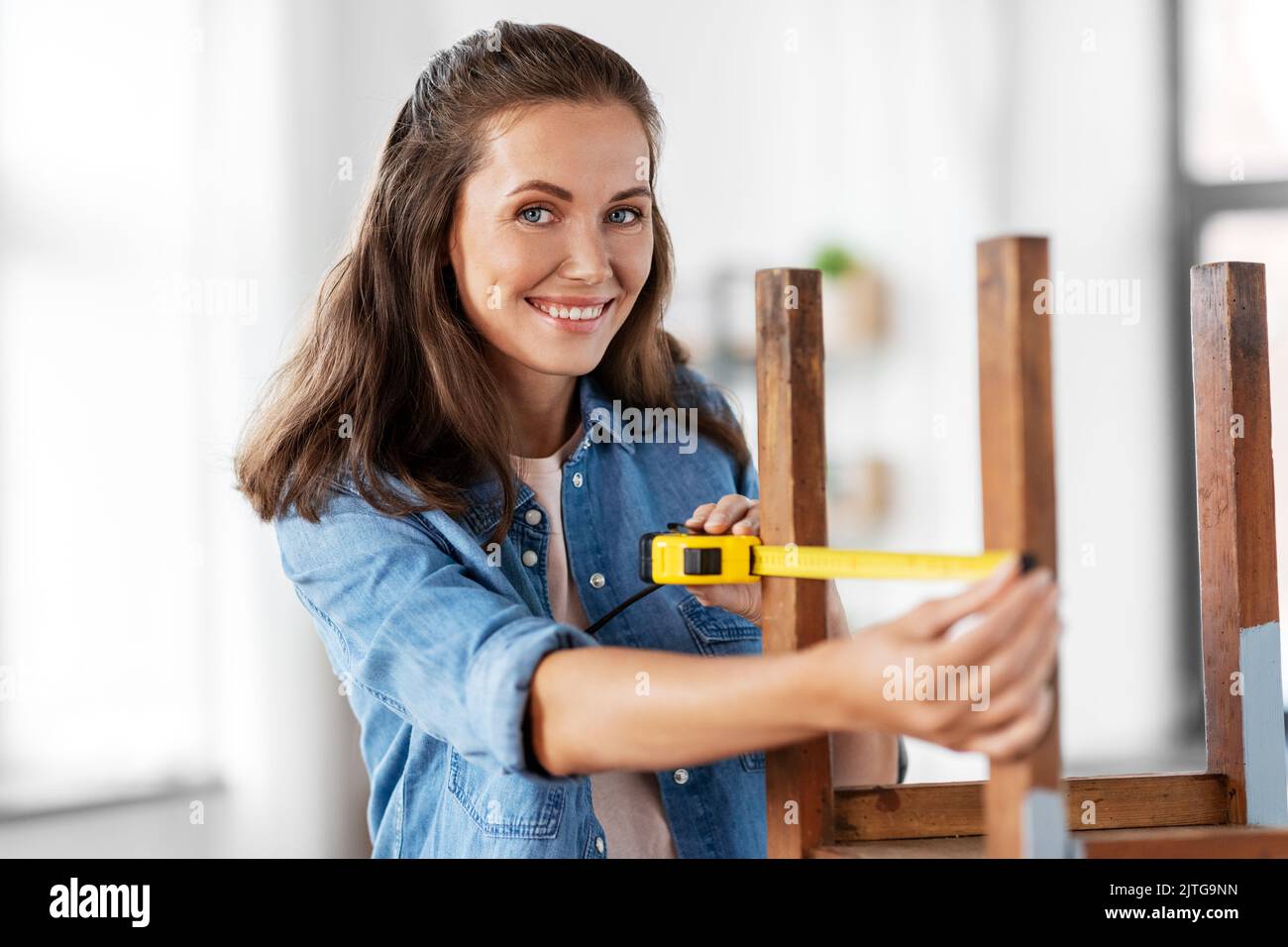 woman with ruler measuring table for renovation Stock Photo - Alamy