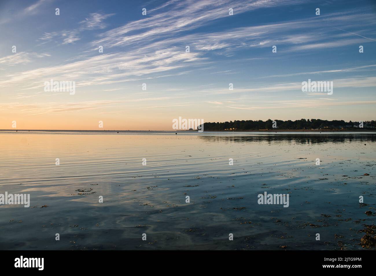 A shallow beach with mesmerizing landscape and cloudscape Stock Photo ...