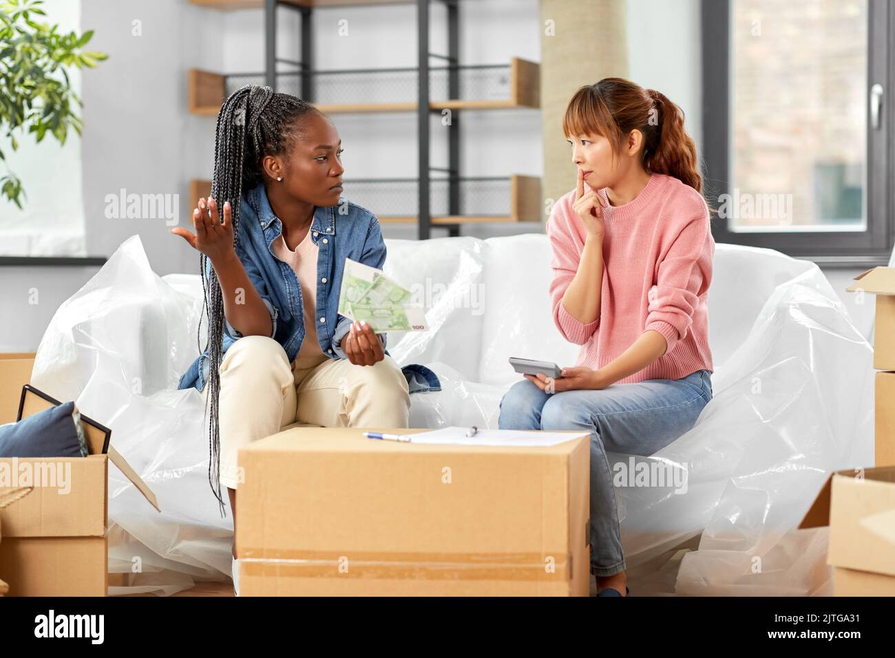 women moving to new home and counting money Stock Photo - Alamy