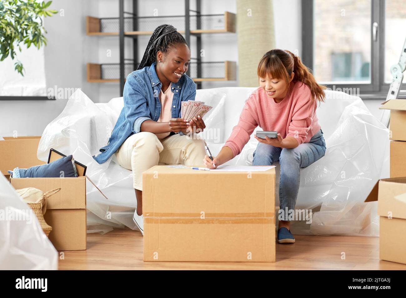 women moving to new home and counting money Stock Photo - Alamy