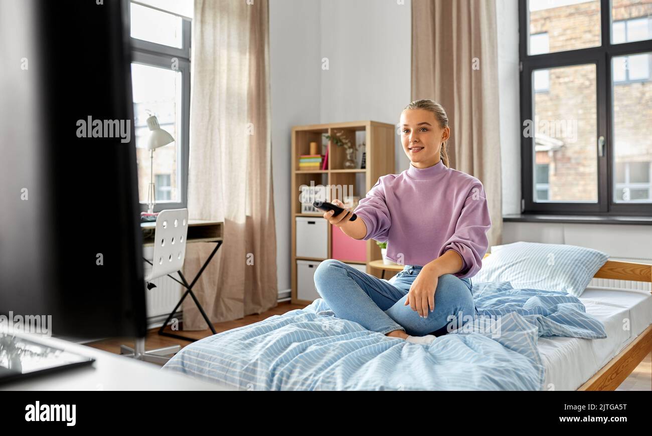 happy smiling girl watching tv at home Stock Photo - Alamy